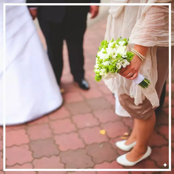 The witness holds a bouquet at the wedding